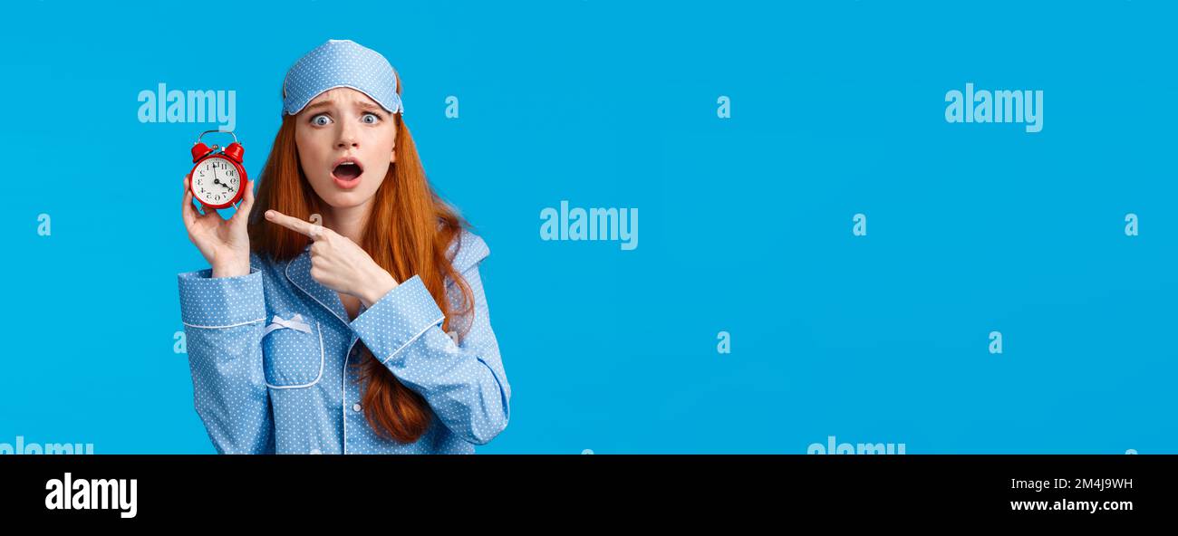 Upset and disappointed gloomy redhead woman in nightwear. sleep mask ...
