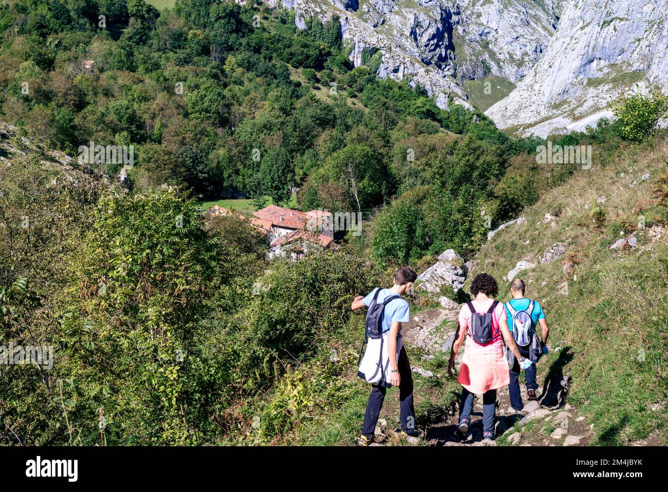 Tourists on a trail in the vicinity of Bulnes de Abajo, La Villa, in ...