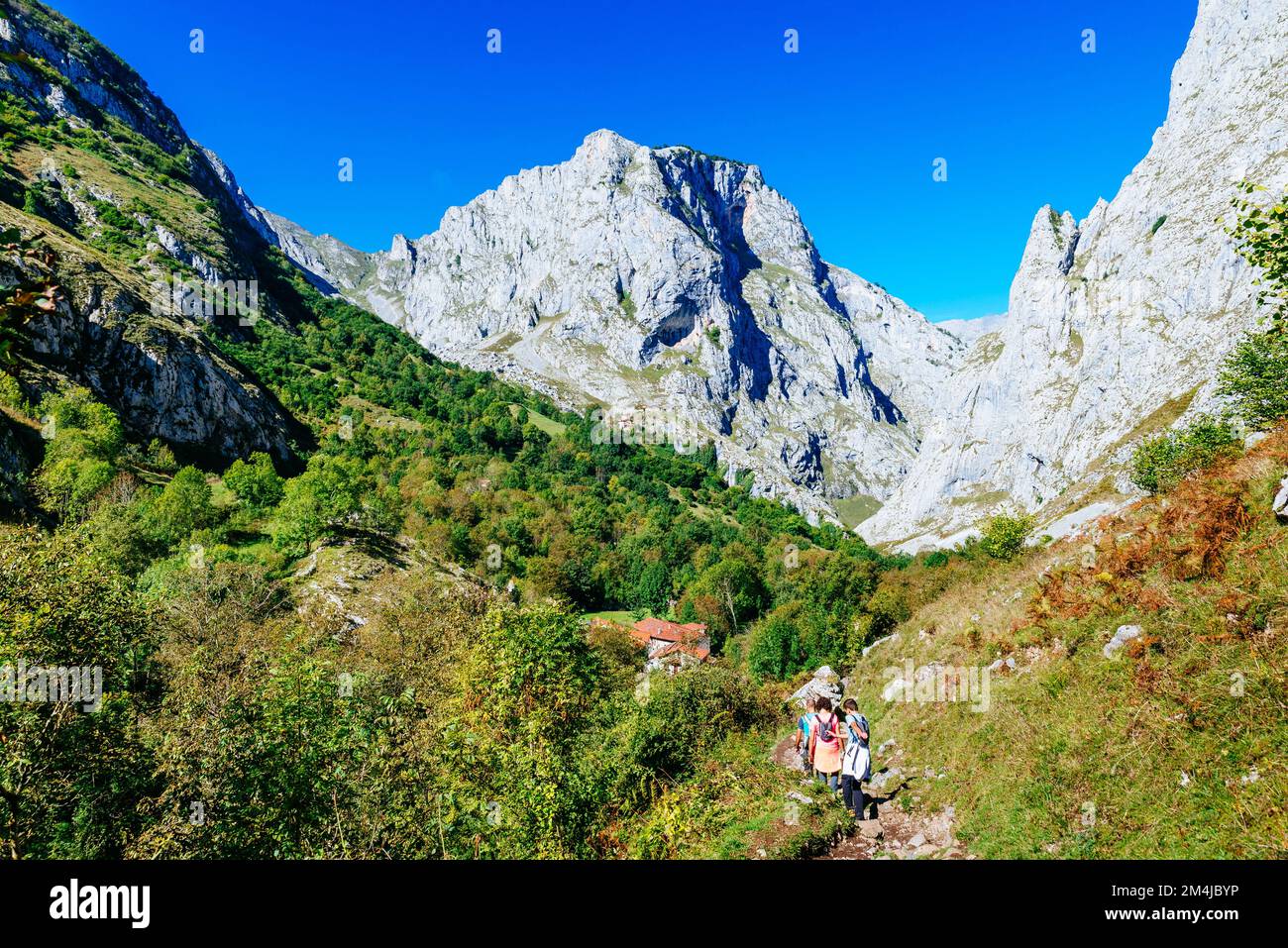 Tourists on a trail in the vicinity of Bulnes de Abajo, La Villa, in ...