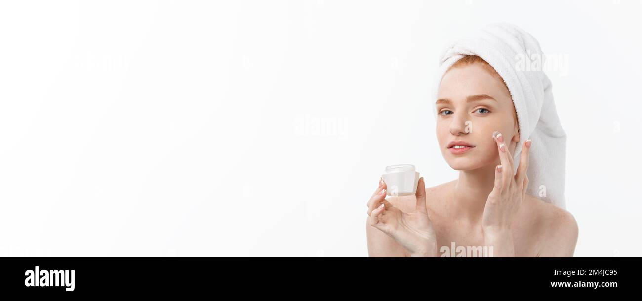 beautiful model applying cosmetic cream treatment on her face on white Stock Photo - Alamy