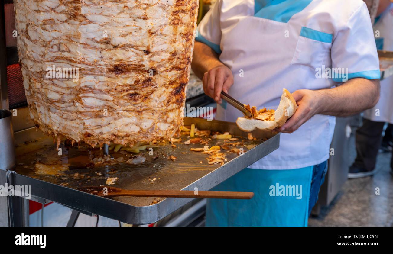 A man preparing shawarma at street market Stock Photo - Alamy