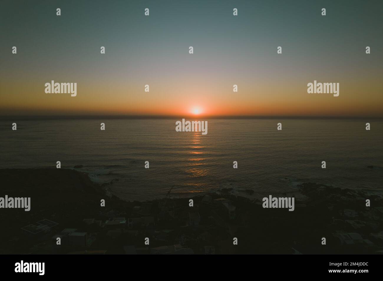 A scenic shot of sunset across a lake over the horizon Stock Photo - Alamy