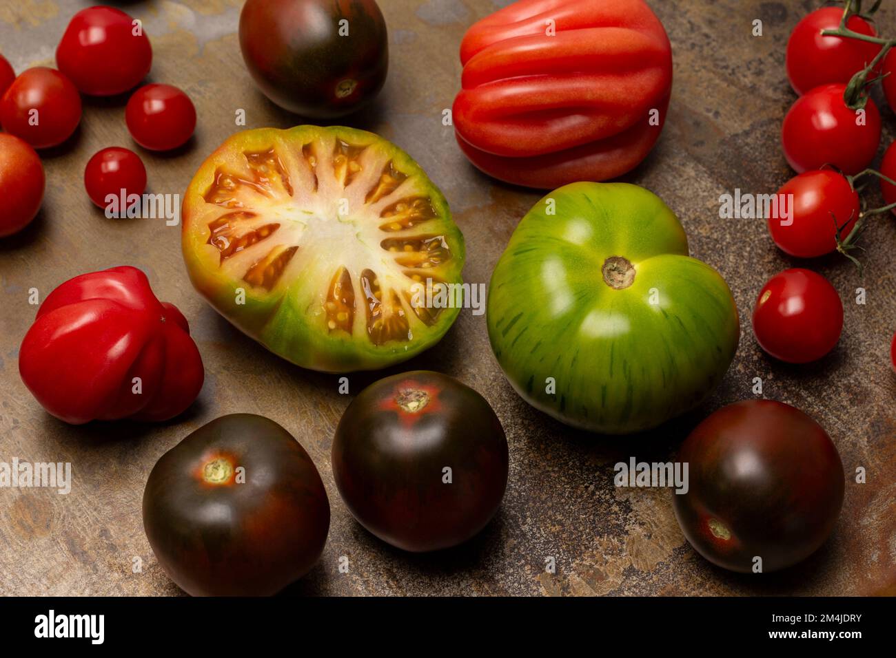 Half a green tomato. Tomatoes of different varieties. Top view. Rusty ...