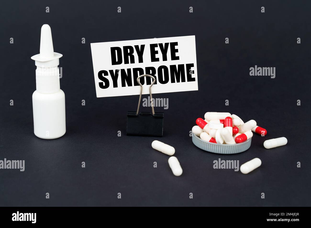 Medical concept. On the black surface of a pill, a nasal spray and a ...