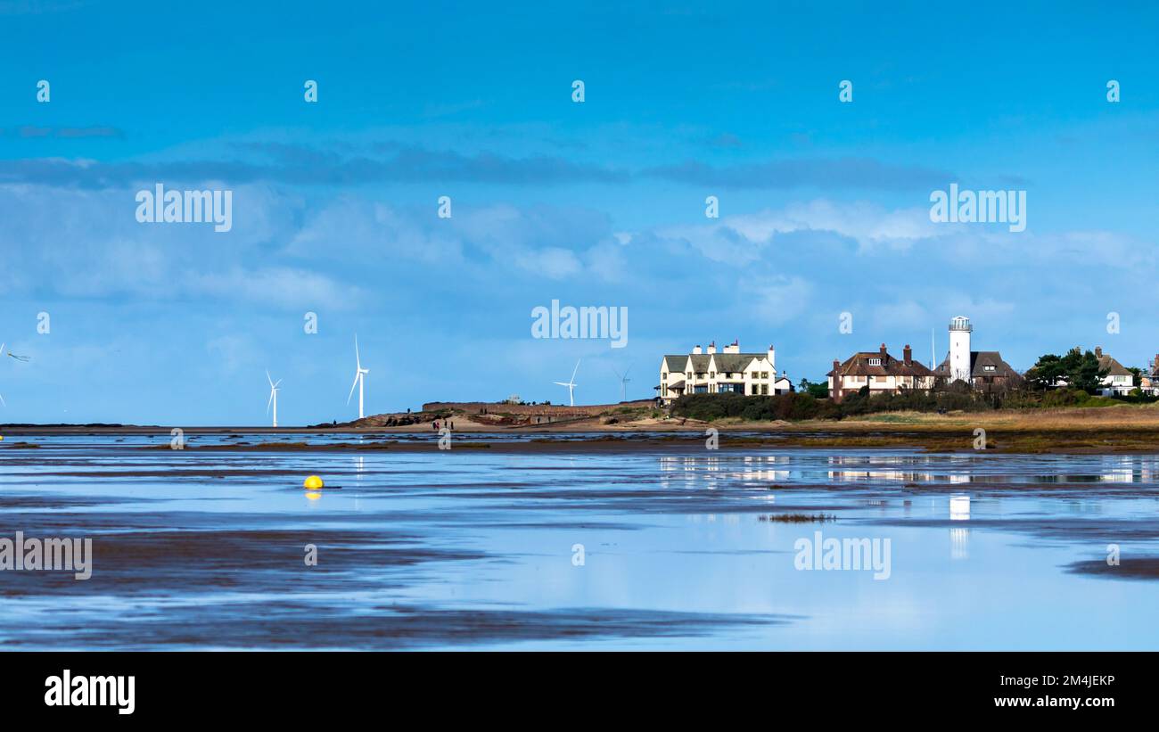 Lighthouse and houses reflected in the shallows at low tide, Hoylake ...