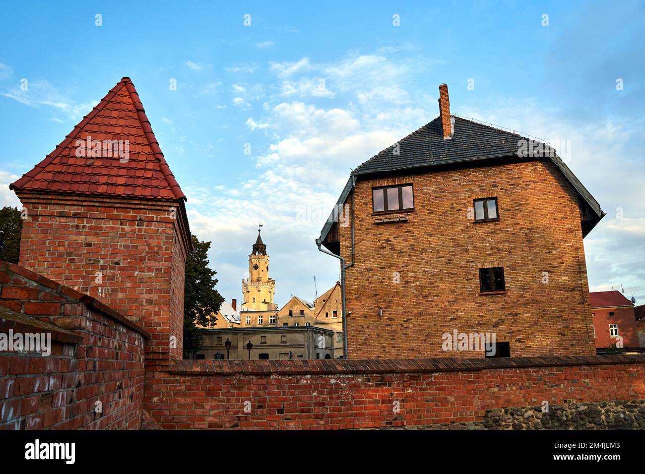 Medieval defensive walls, historic tenement houses and the tower of the ...