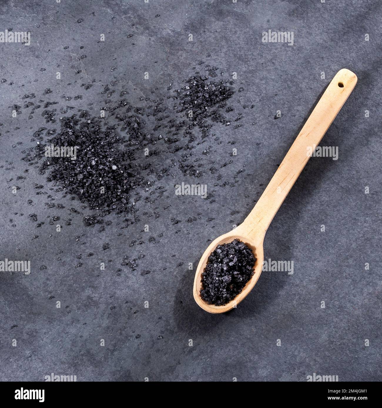 Hawaiian natural black salt in the wooden spoon Stock Photo - Alamy