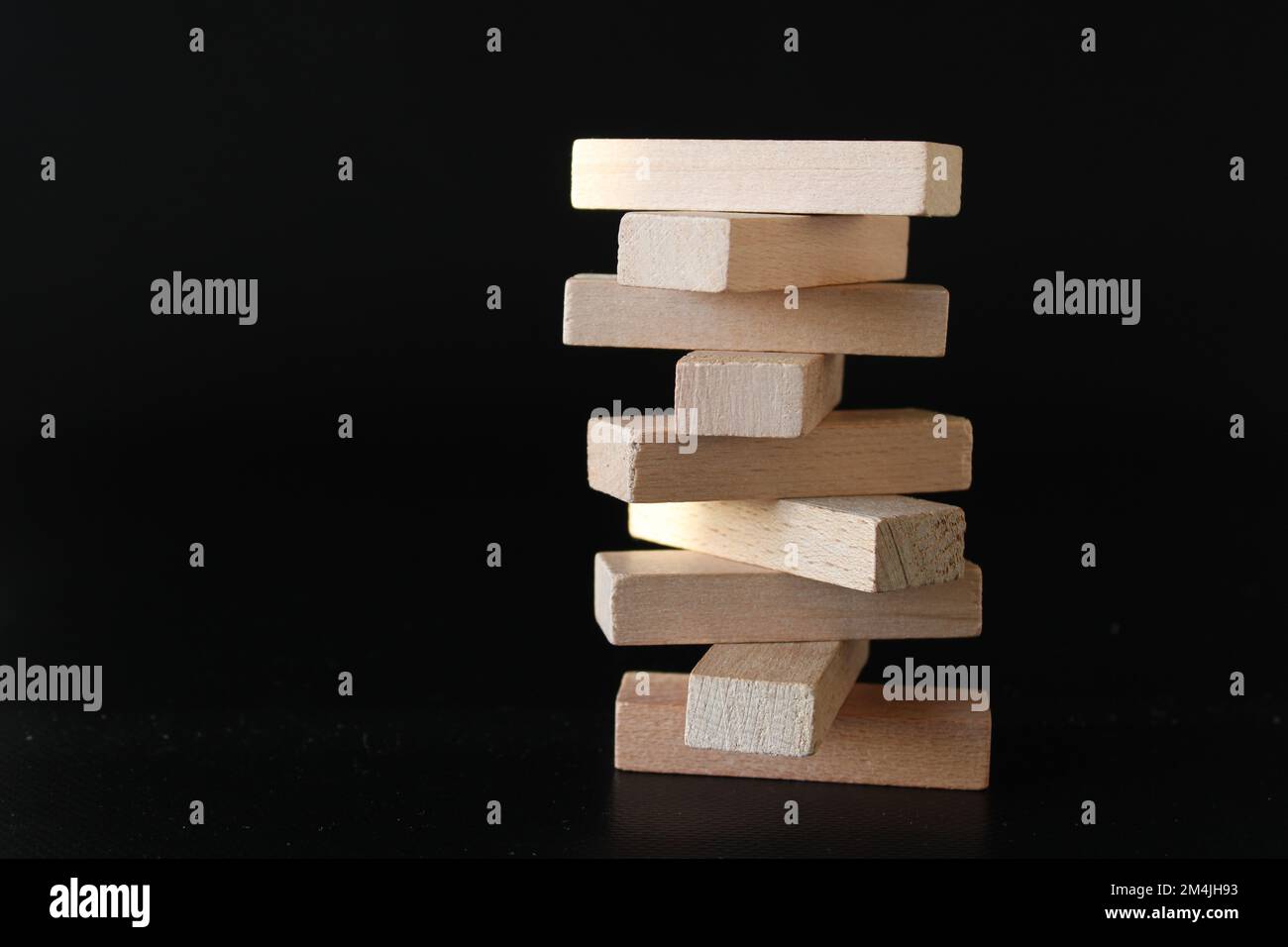 wooden blocks lined up in rows on black background Stock Photo - Alamy