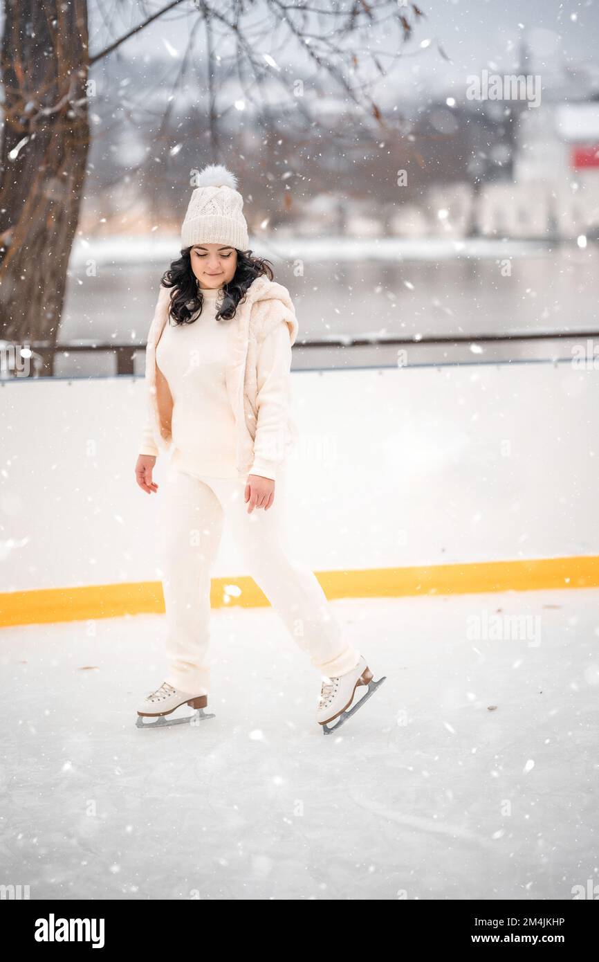 Beautiful girl having fun while skating at ice rink on Prague castle ...