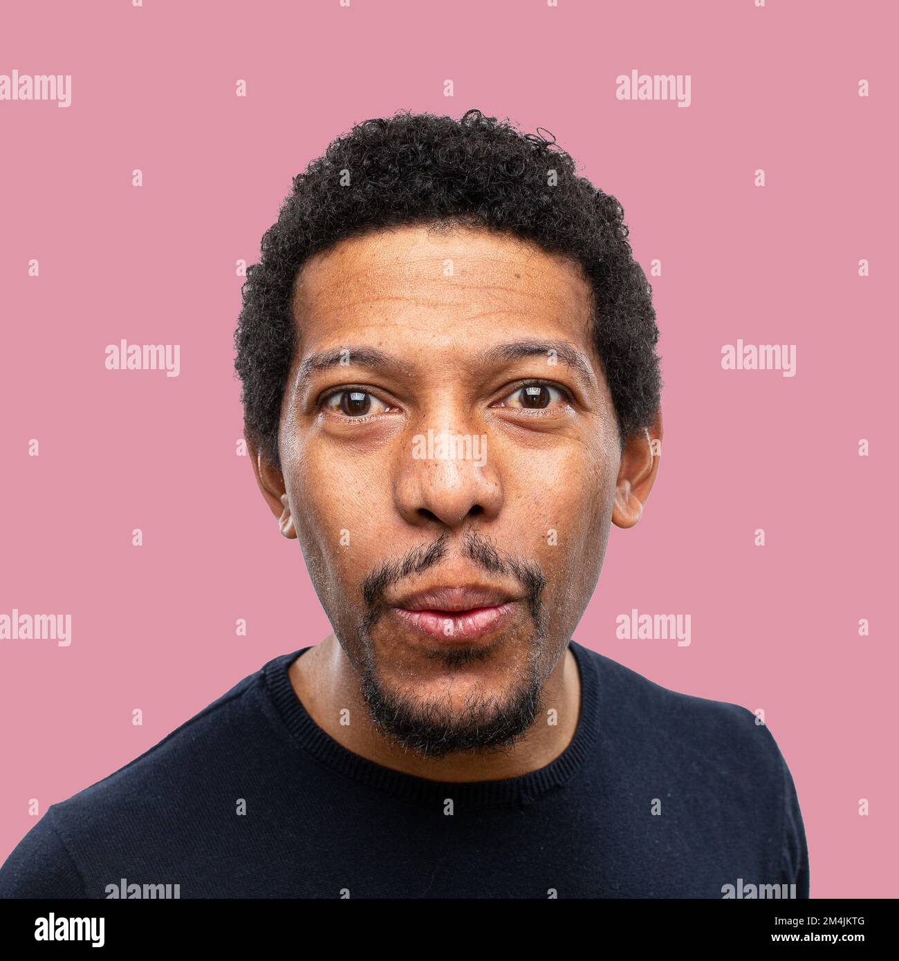 African boy with a happy expression of victory blowing like in a sigh ...