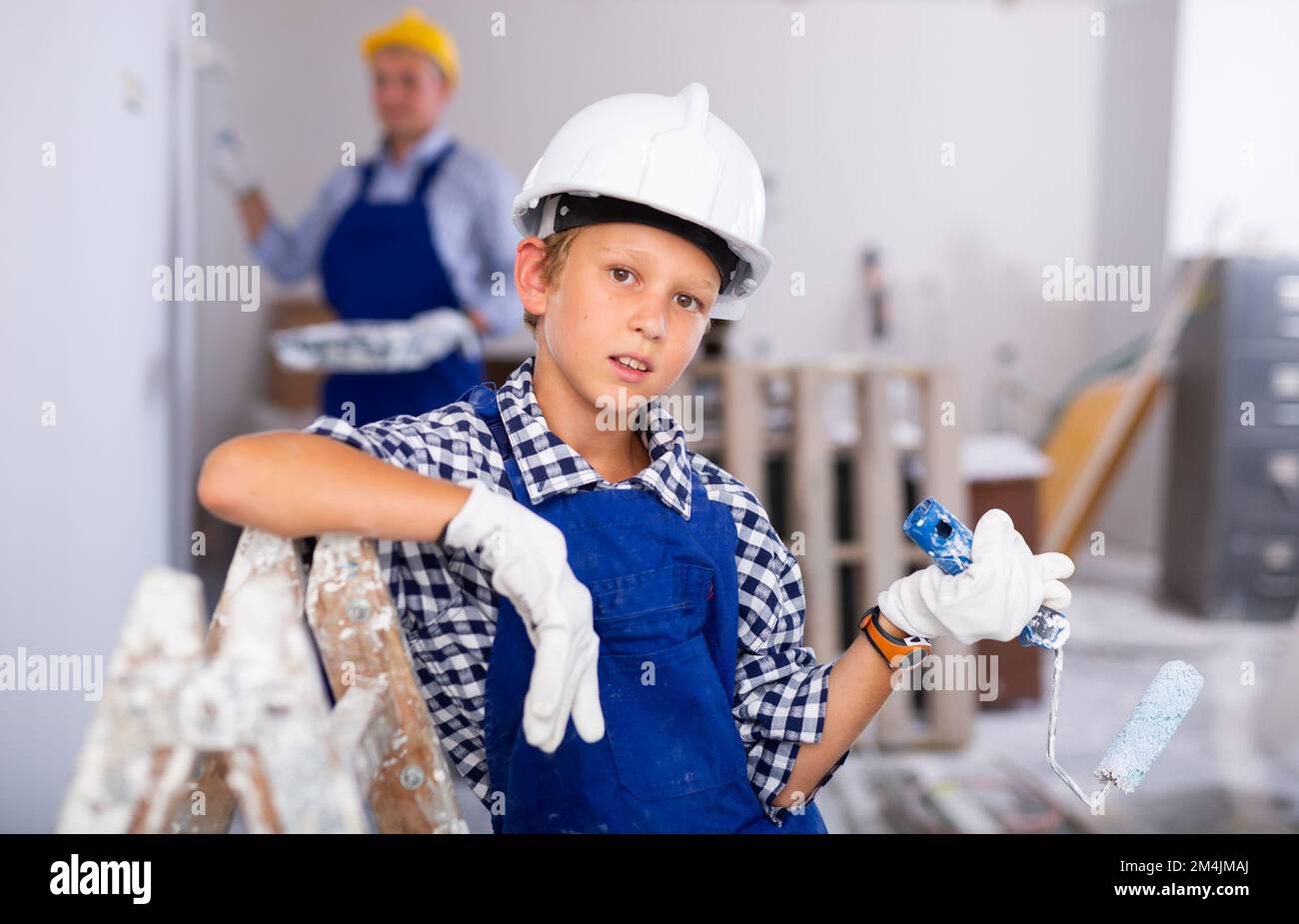 Boy posing with tools for home renovation Stock Photo - Alamy