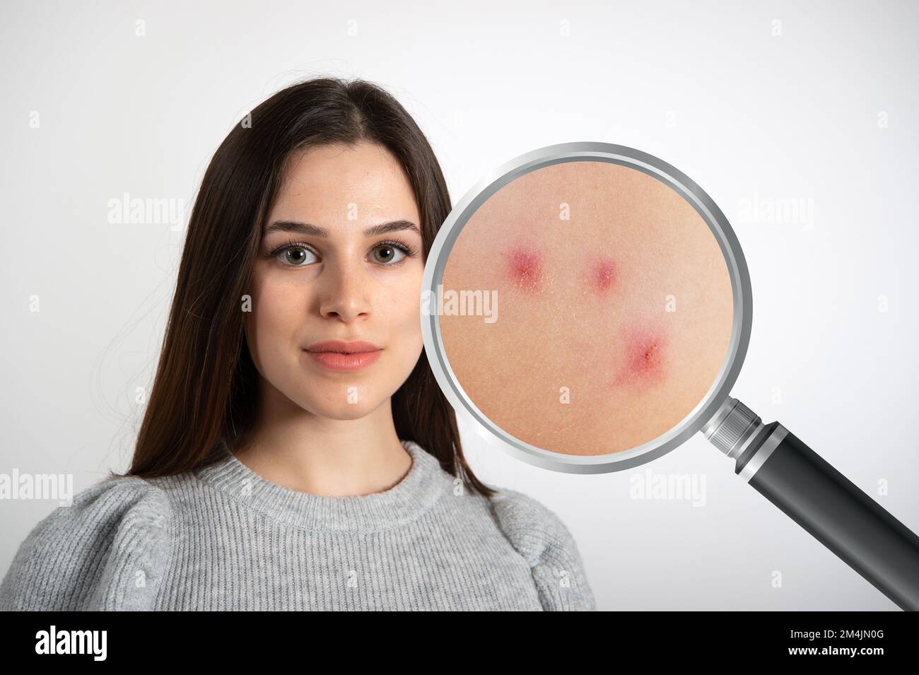 Portrait of a young model where through a magnifying glass you can see ...