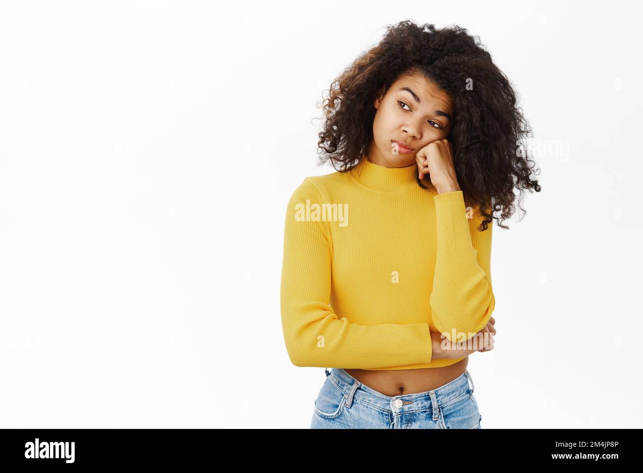 Sad teen african girl with curly hair, looking bored at left side ...