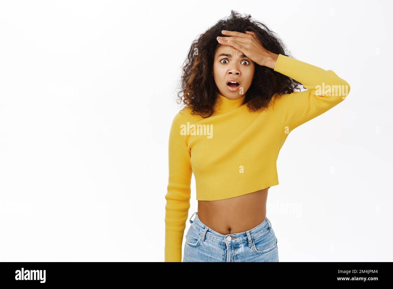 Portrait of shocked, concerned black woman, slap her forehead, looking ...