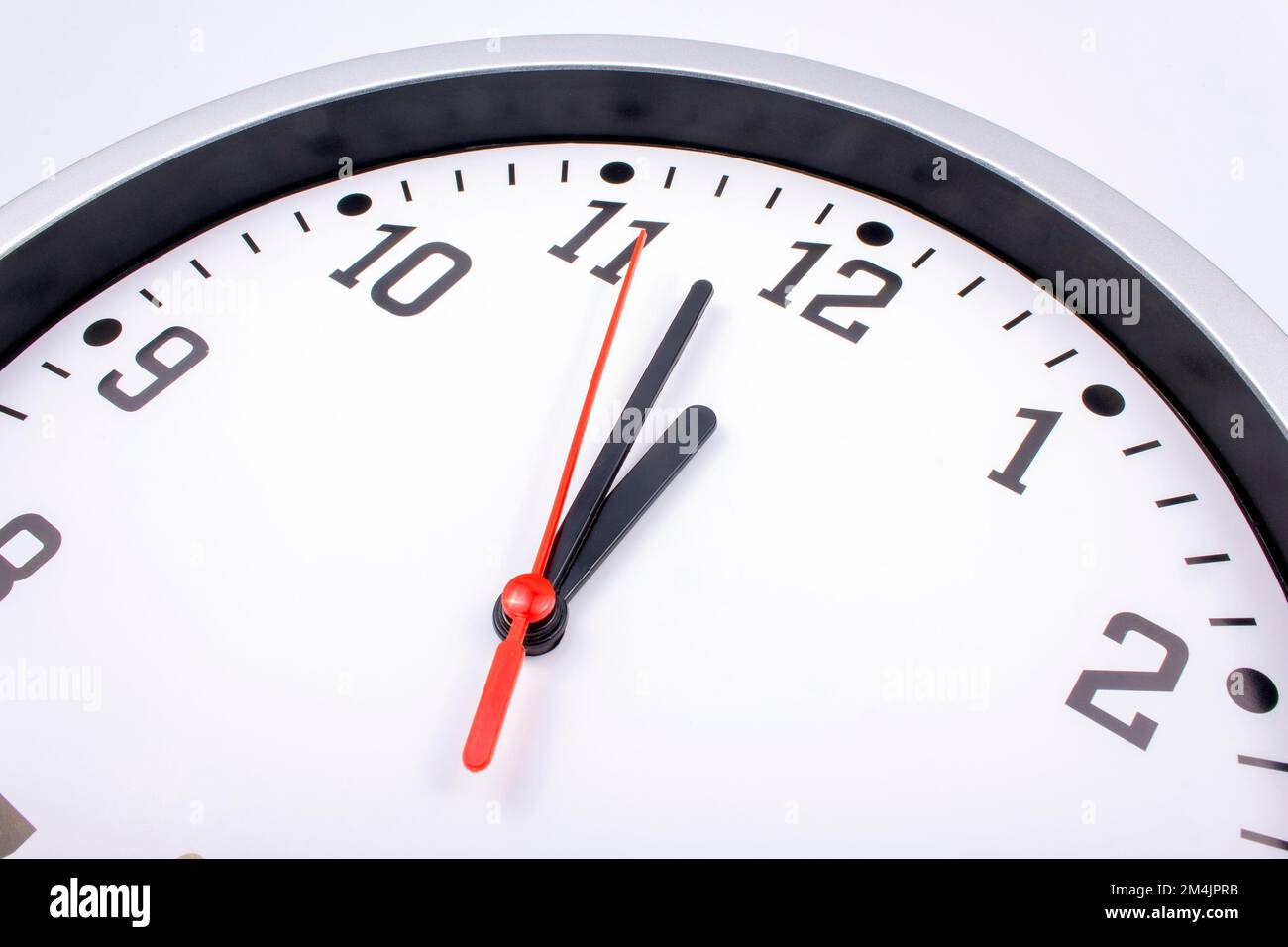 Midnight is coming. Black and white office clock with a red pointer ...