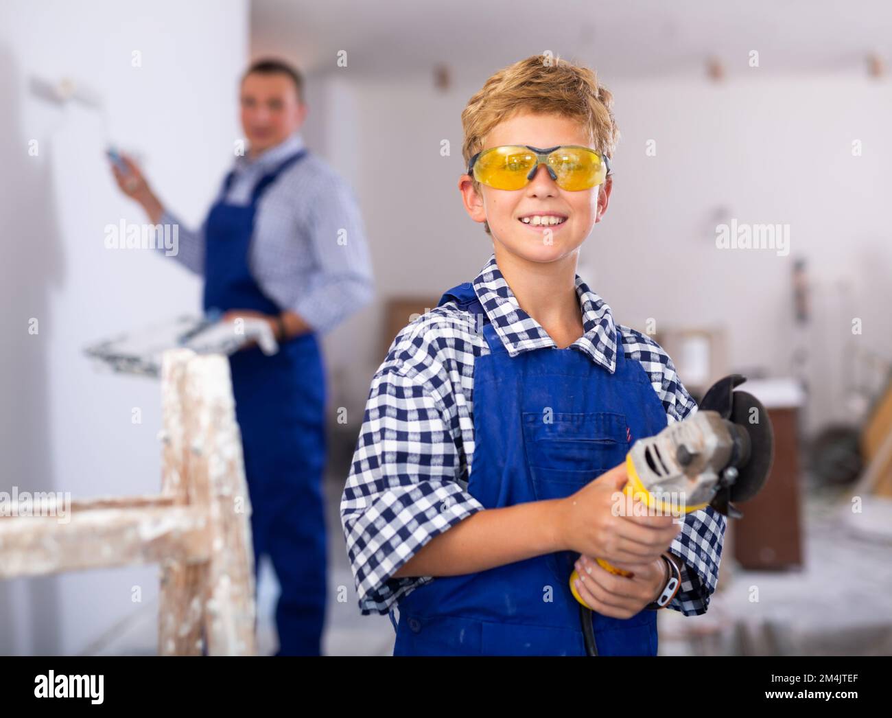 Emotional preteen boy posing with grinder machine Stock Photo - Alamy