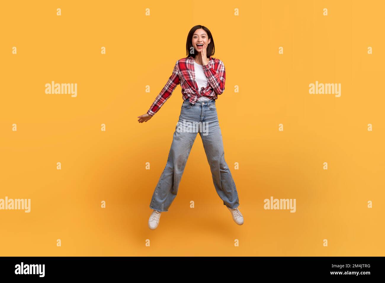 Wow. Full body length shot of surprised asian lady jumping, shocked by ...