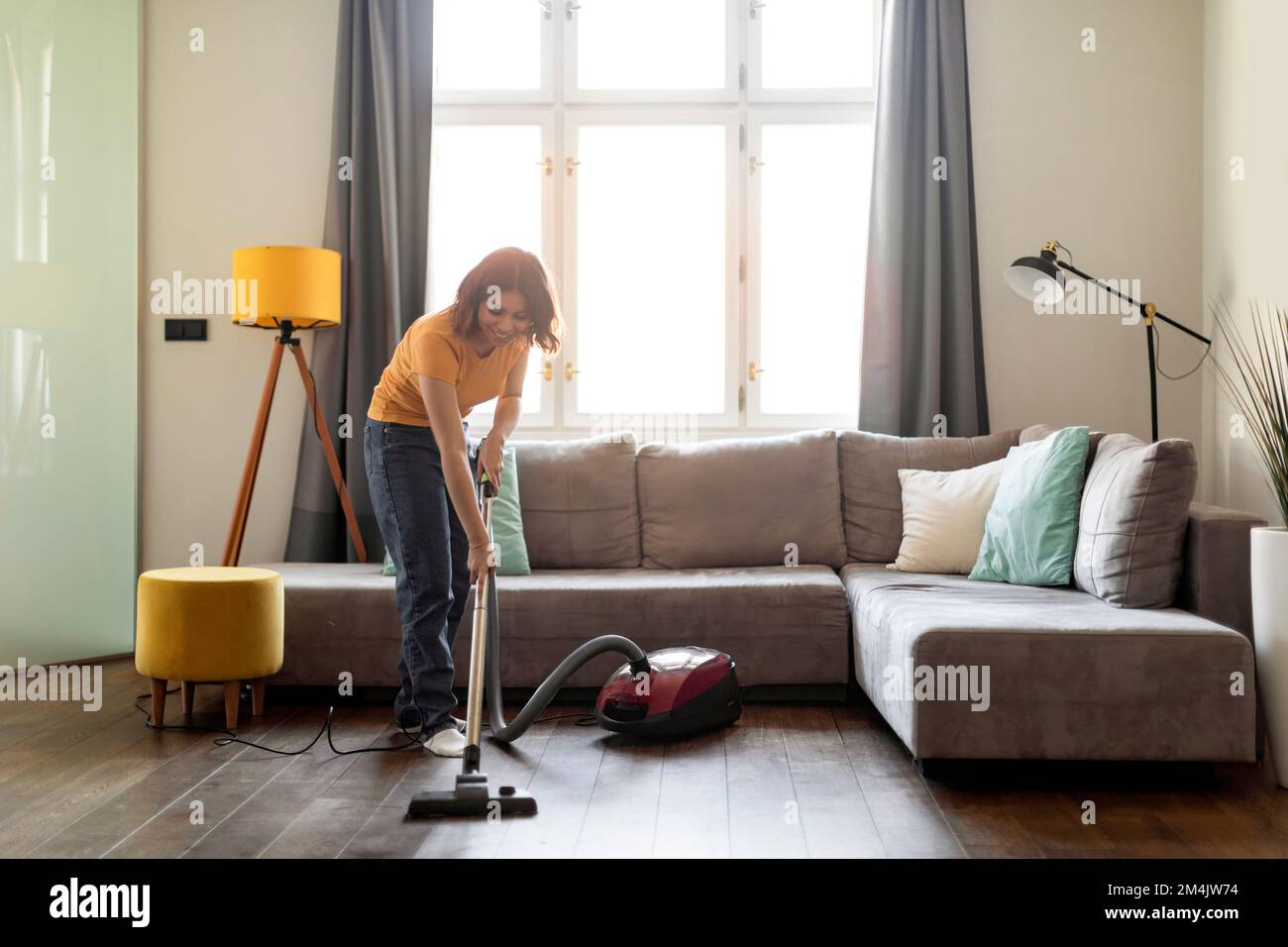 Domestic Chores. Young Arab Woman Making Cleaning In Living Room, Hoovering Floor Stock Photo ...