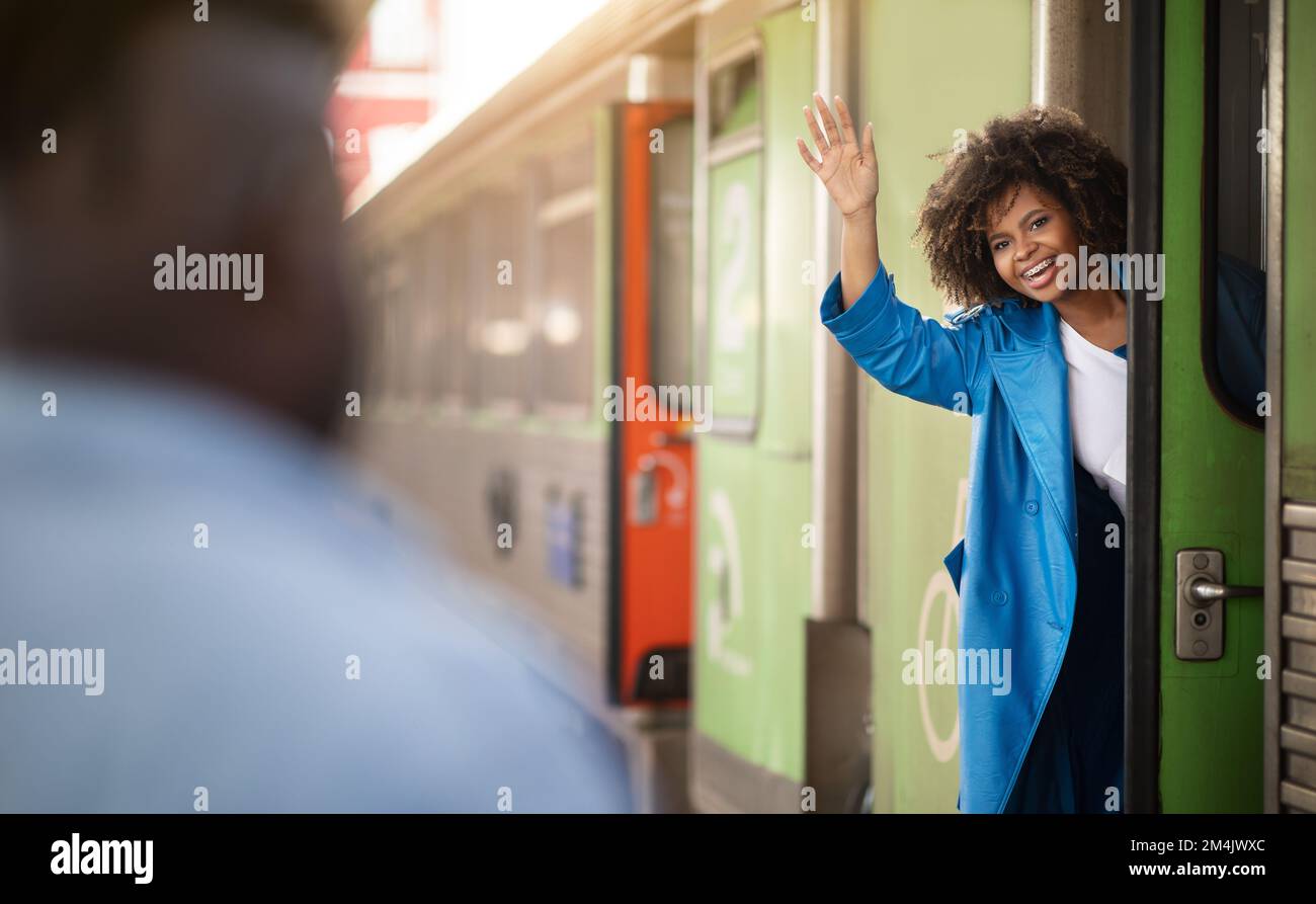 Happy Black Female Standing In Train Door And Waving Hand To Boyfriend ...
