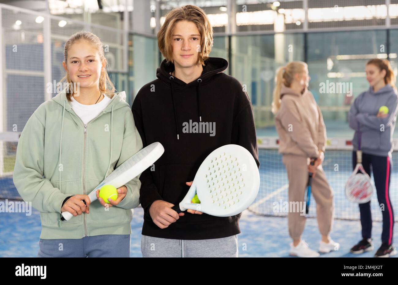 Teenage boy and girl in padel court Stock Photo - Alamy
