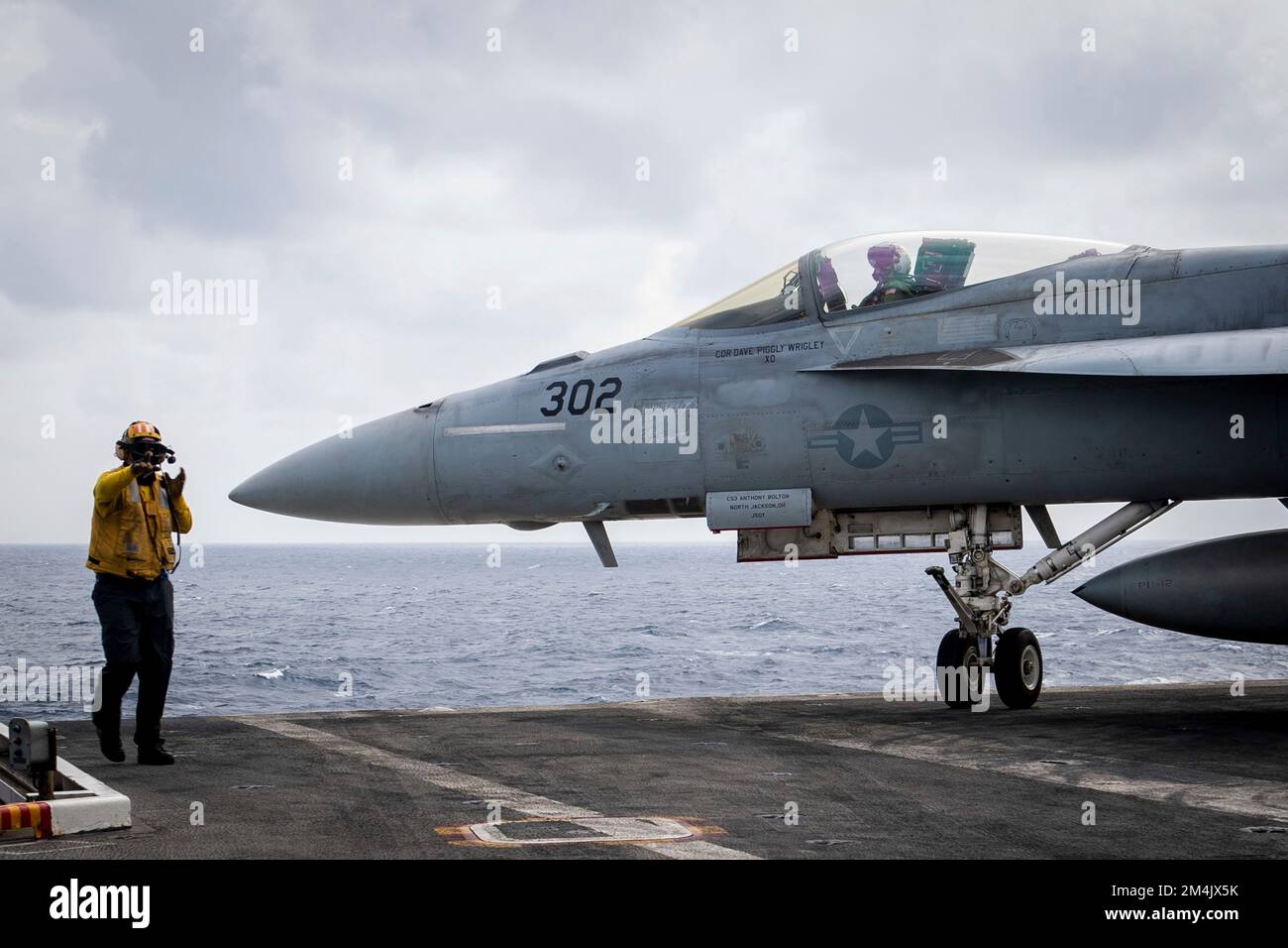 Pacific Ocean, International Waters. 20 January, 2021. A U.S Navy sailor directs a F/A-18E Super ...