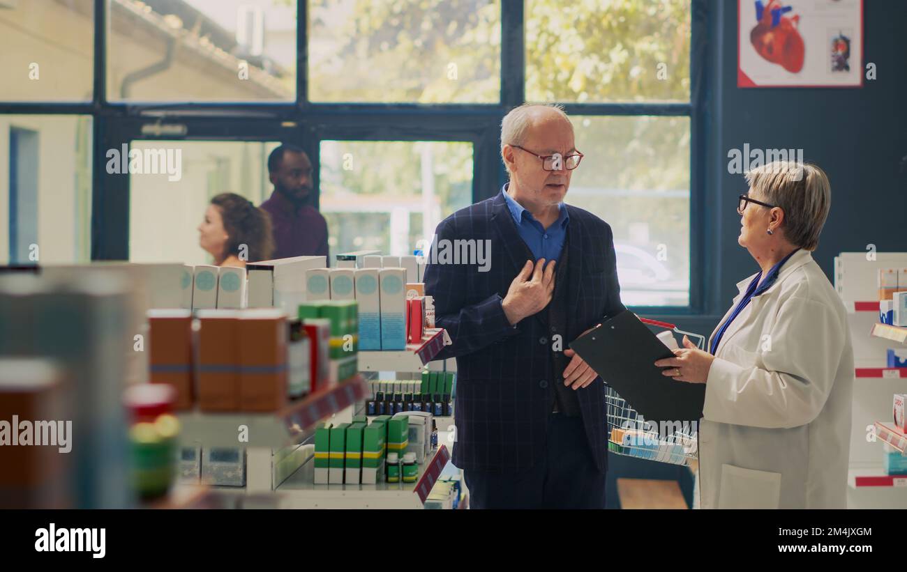 Elderly person with heartache talking to pharmacist about cardiology ...