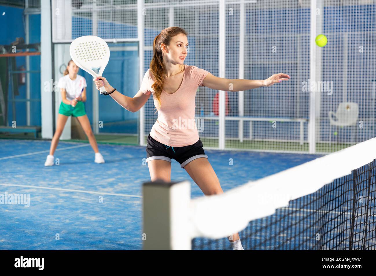Active sports girl playing padel on tennis court Stock Photo - Alamy