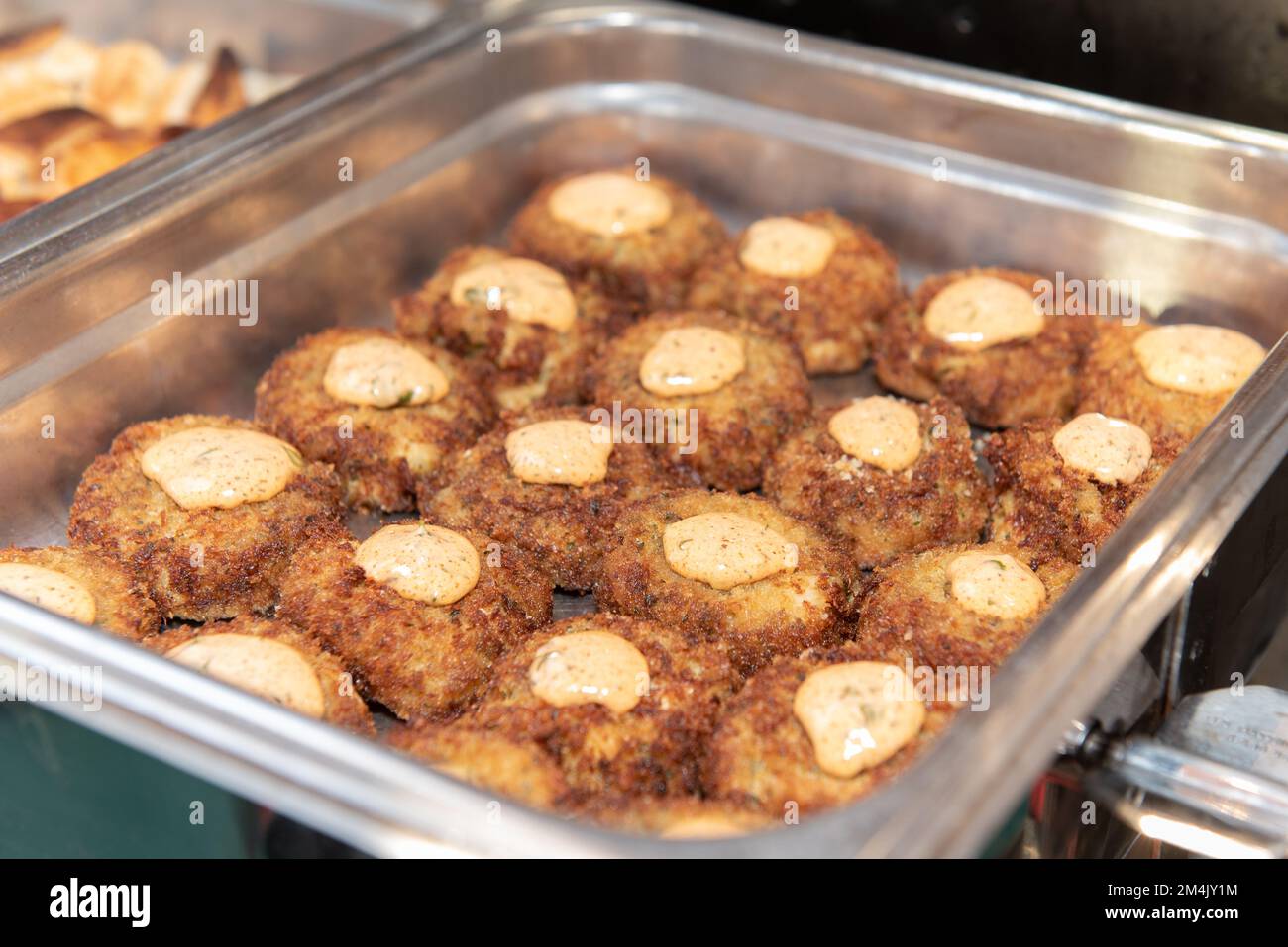 Buffet table with a chaffing dish full of crispy crabcakes for the ...