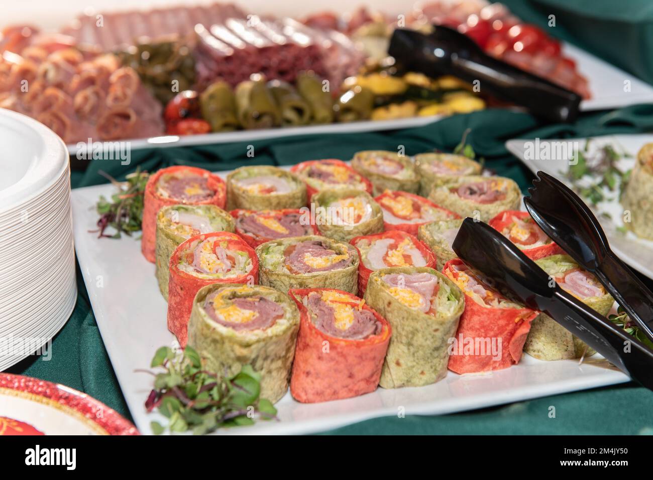 Buffet table full of different appetizers along with turkey wraps for ...