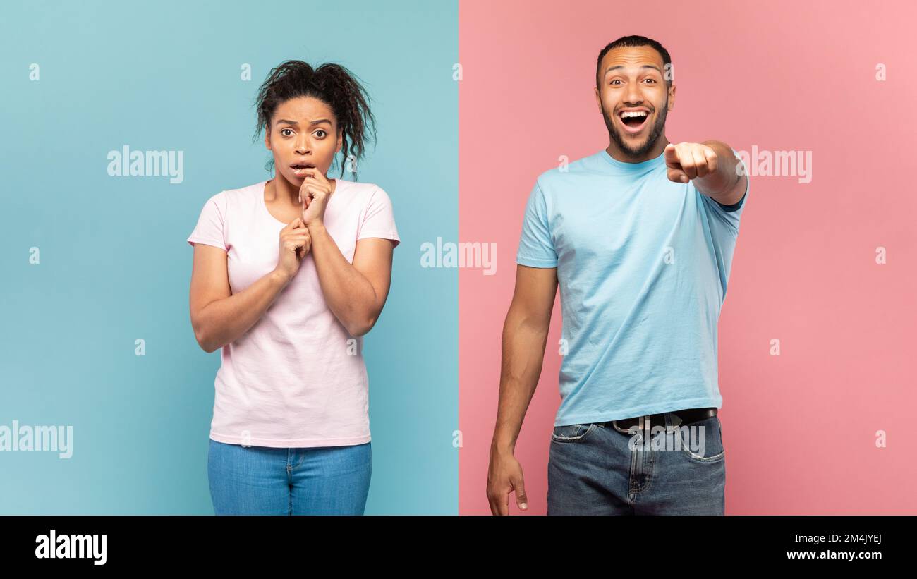 Shocked black couple gaze straightly at camera, happy man pointing at ...