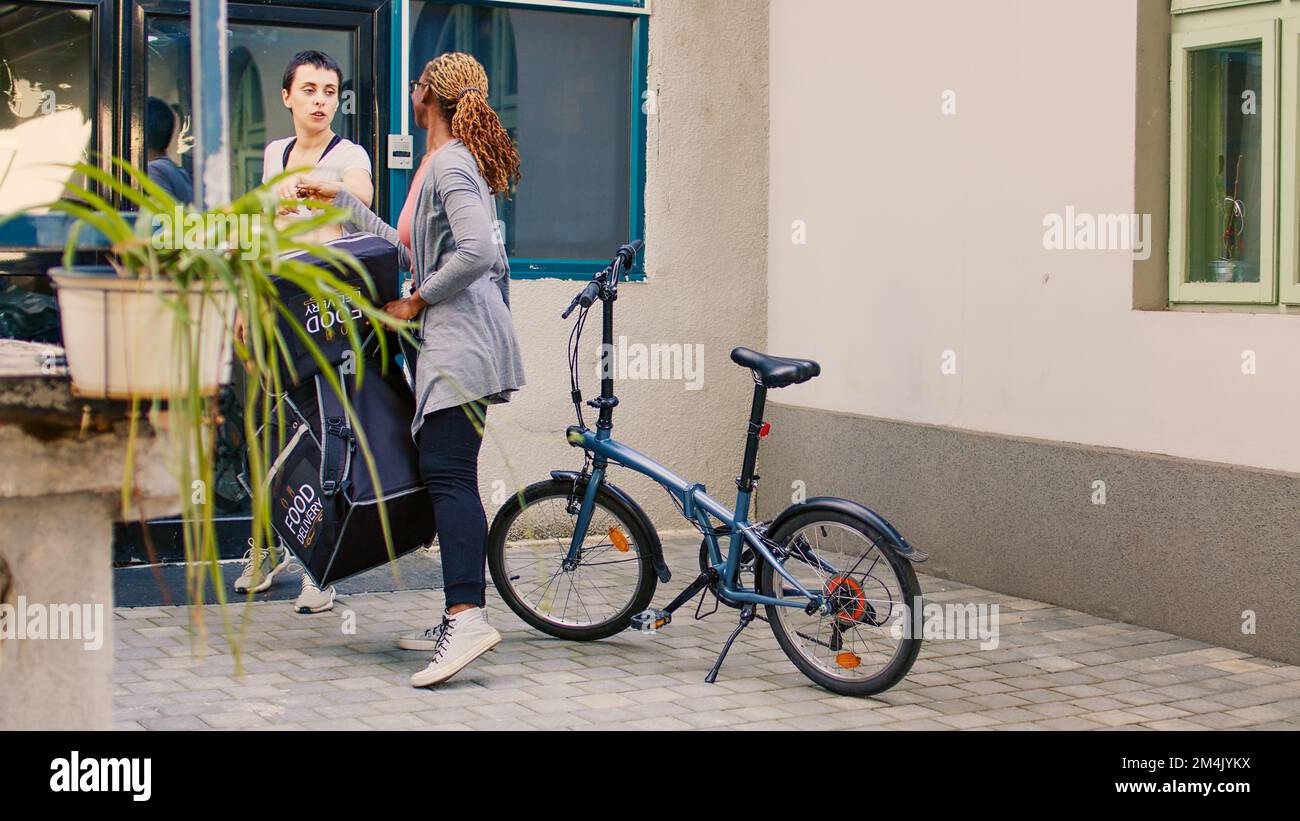 Express food delivery service courier delivering lunch in paper bag ...