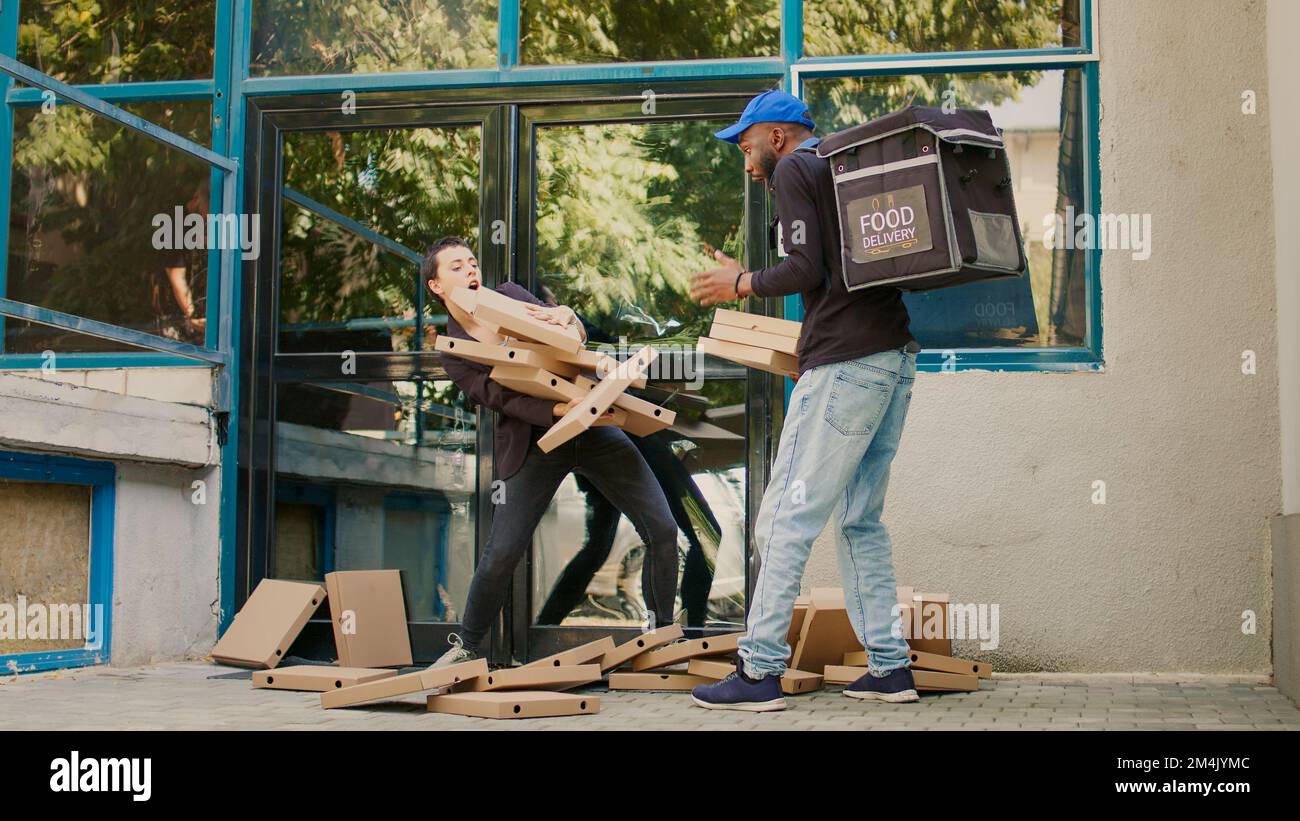 Clumsy restaurant courier dropping pizza boxes pile in front of ...