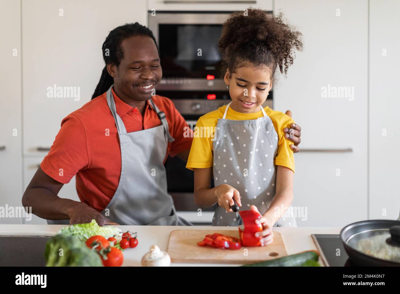 Happy African American Dad And Daughter Cooking Together In Kitchen ...