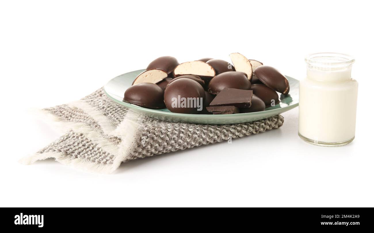 Plate with sweet chocolate bird's milk candies, kitchen towel and ...