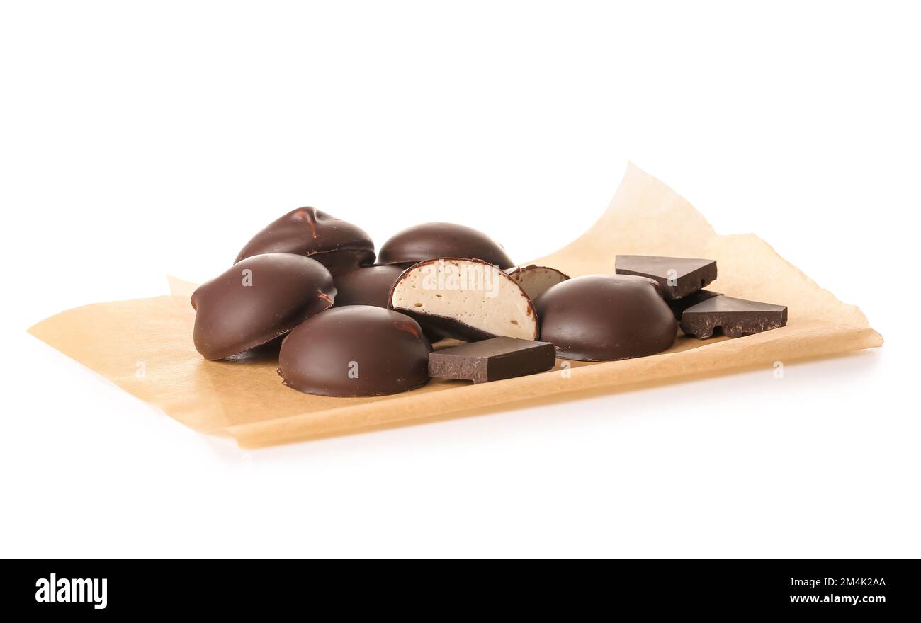 Parchment with sweet chocolate bird's milk candies on white background ...