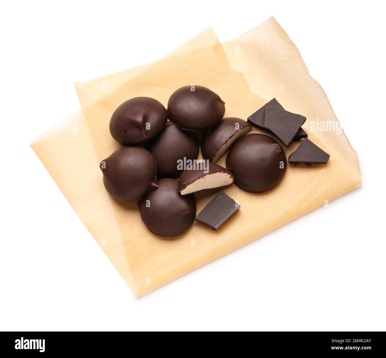 Parchment with sweet chocolate bird's milk candies on white background ...