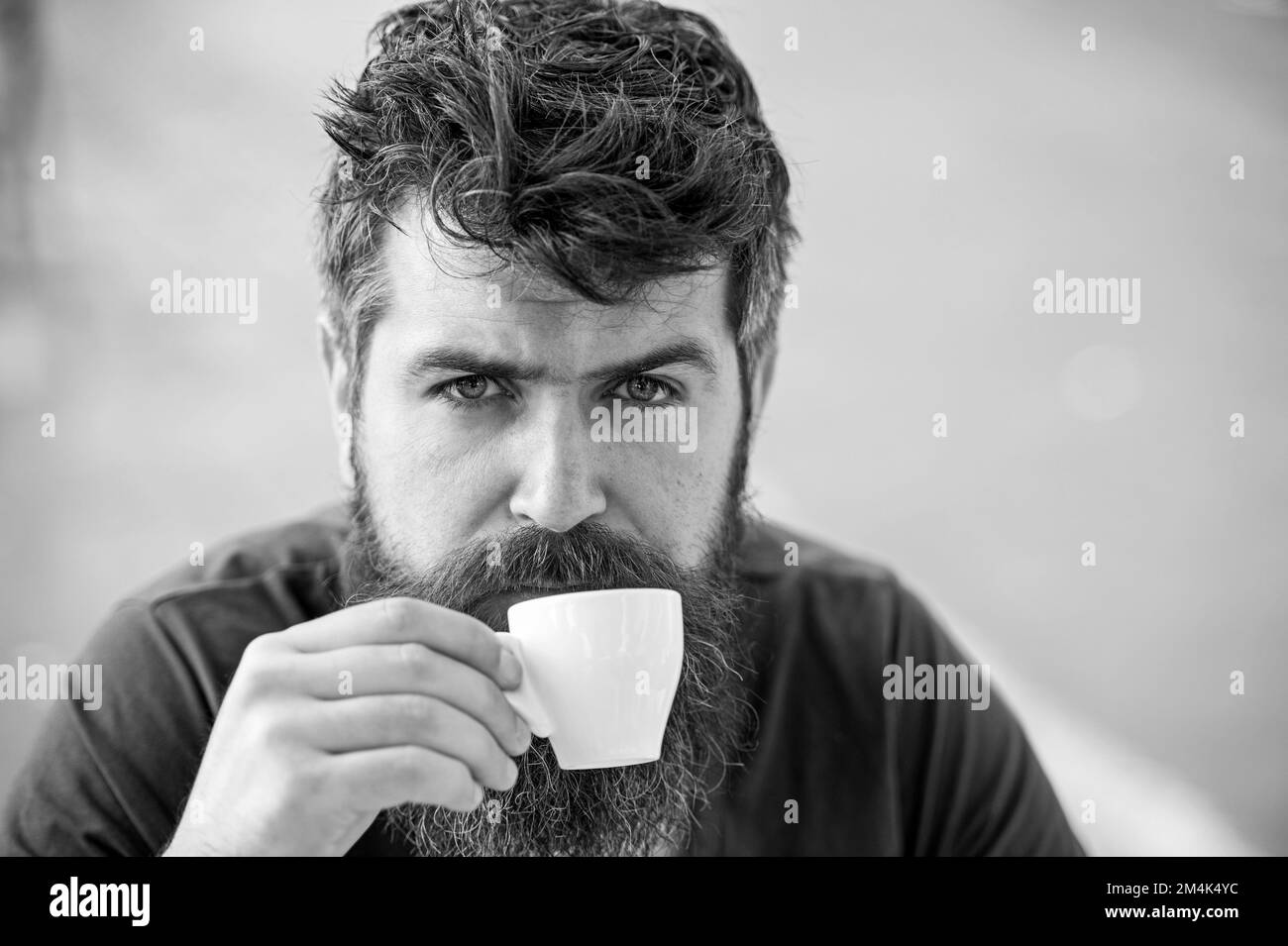 Coffee break concept. Man with long beard looks calm and relaxed. Man ...