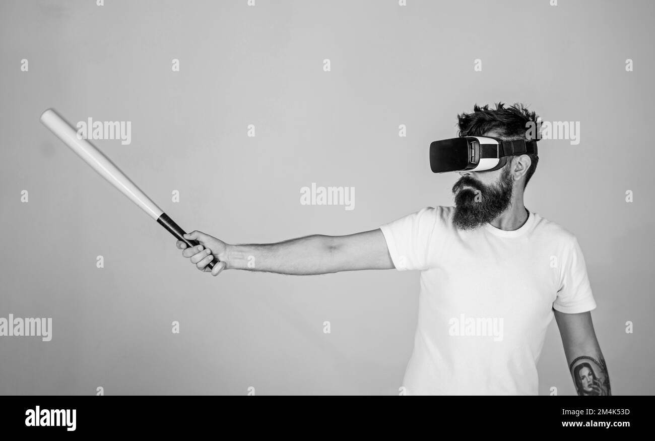 Man with beard in VR glasses, grey background. Guy with VR glasses play ...