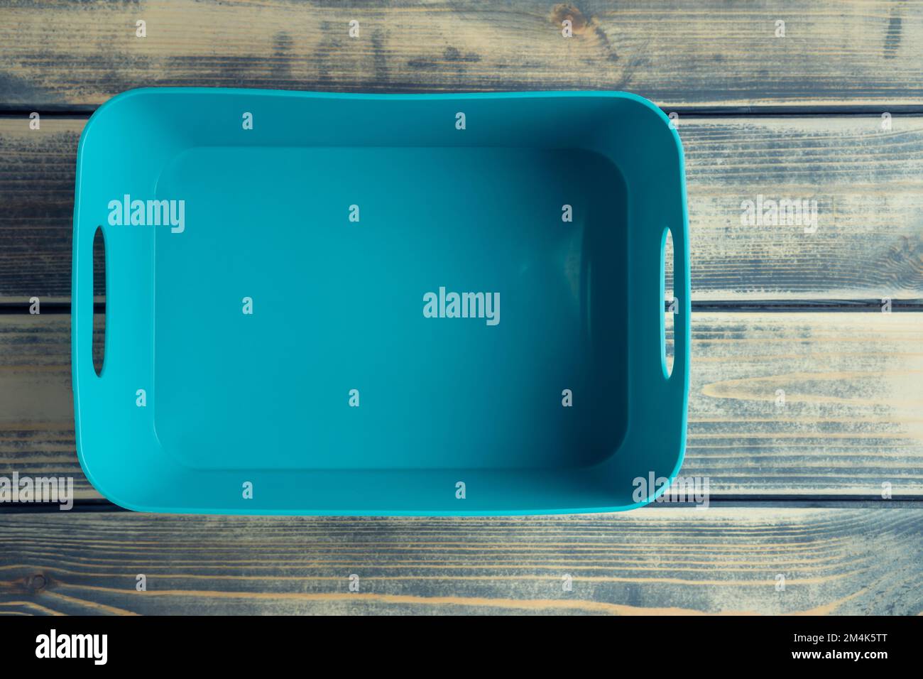 Blue empty plastic cube box on wooden table background. Sustainable ...