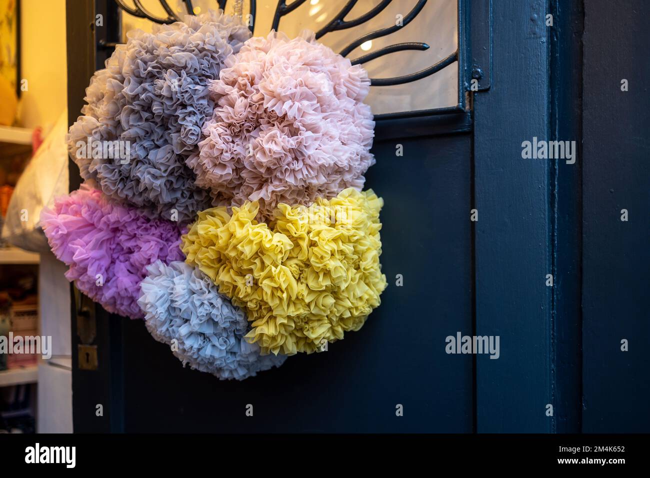 Christmas wreath of large multi-colored paper and rag balls in pastel ...