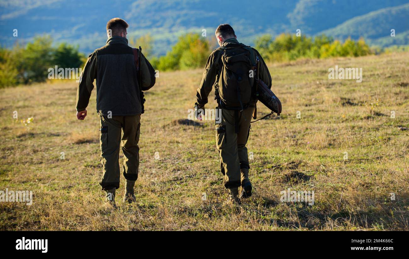 Hunters friends gamekeepers walk mountains background. Hunters rifles ...