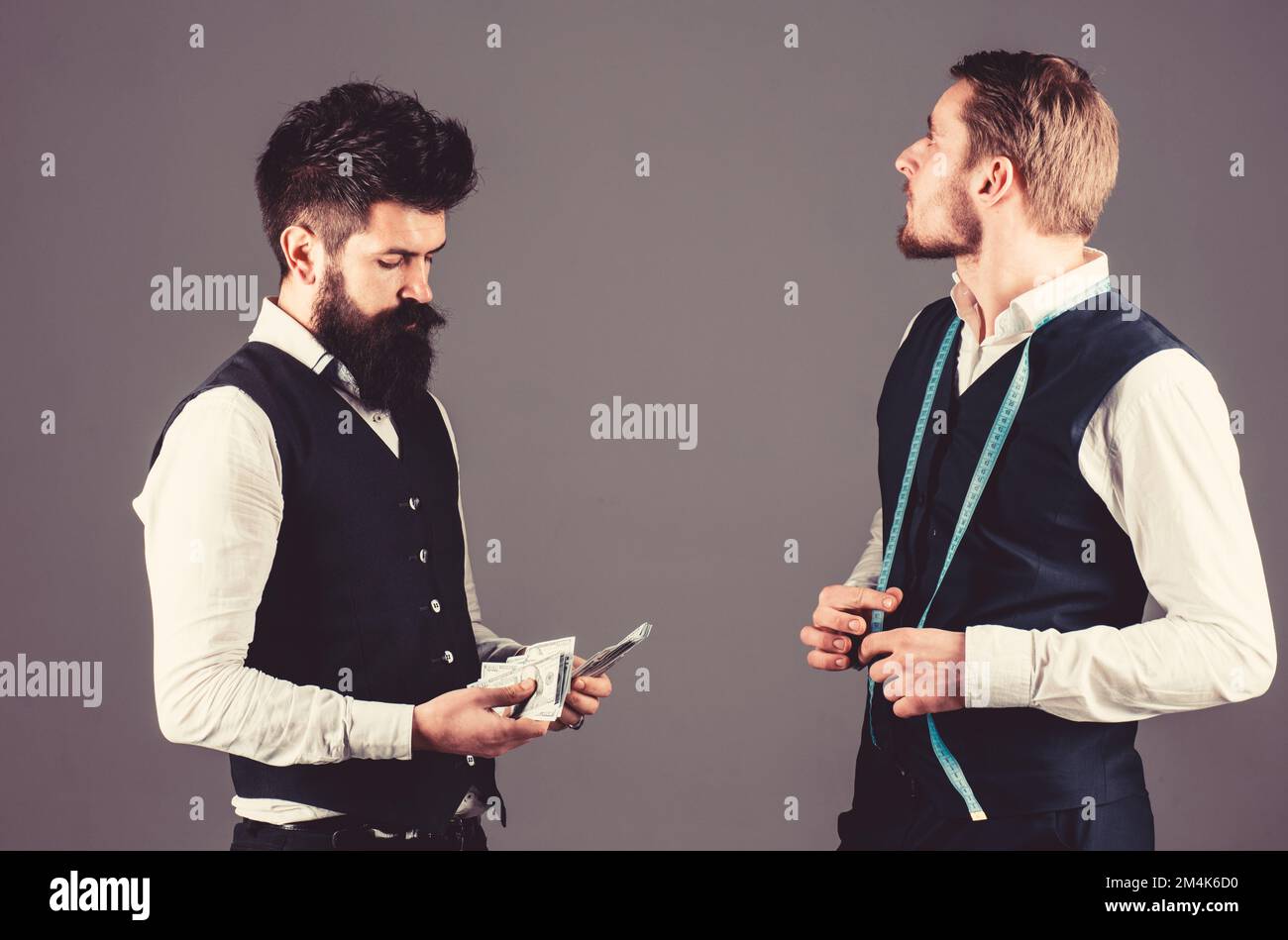 Customer, client paying, counting money, grey background Stock Photo ...