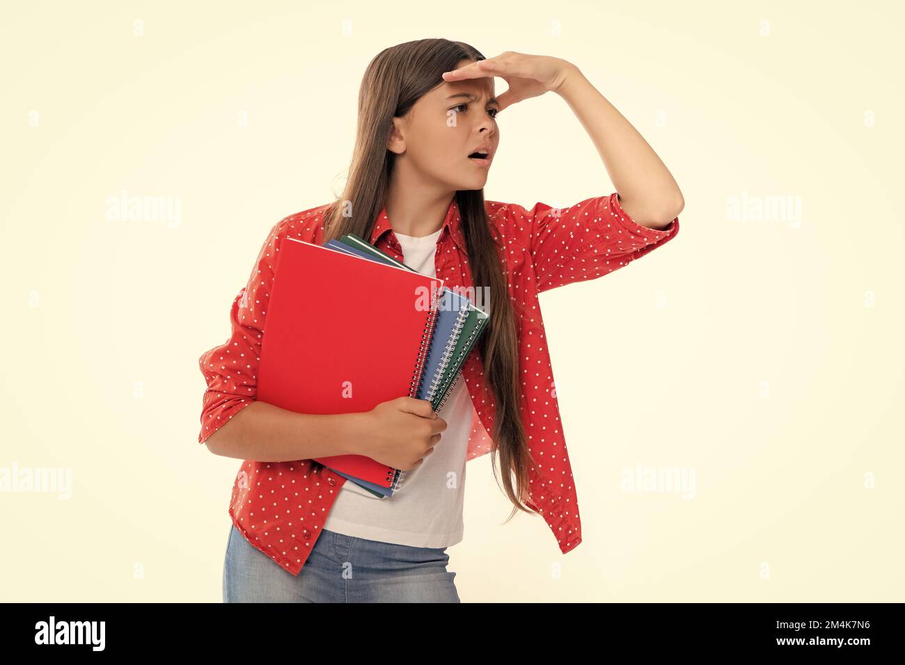Teenager school girl with books isolated studio background. Angry ...