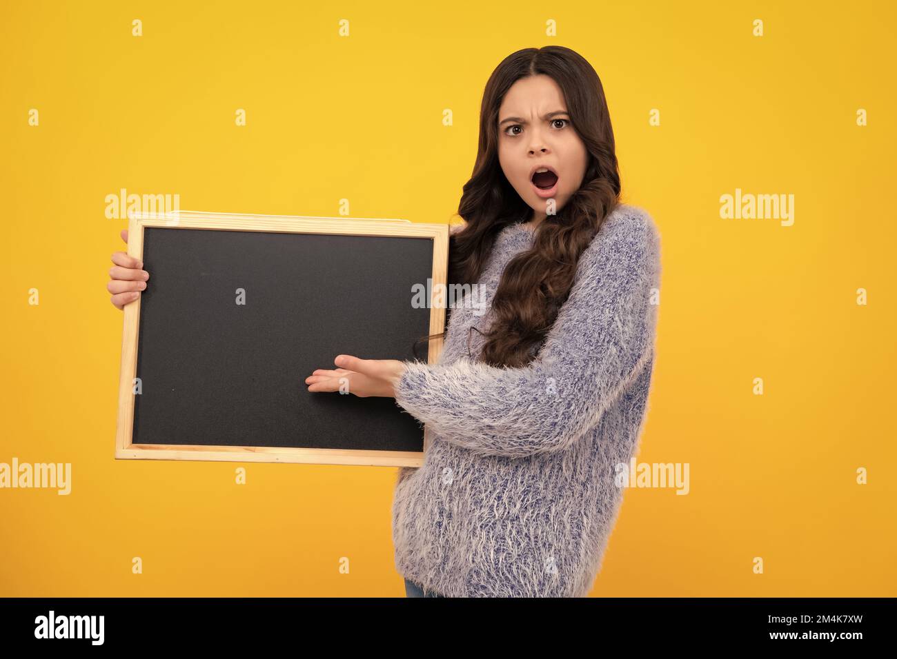Teenager younf school girl holding school empty blackboard isolated on ...