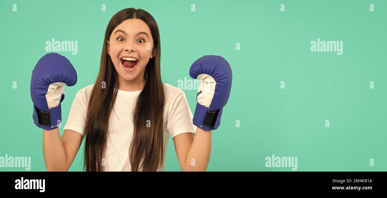 surprised teen girl boxer in boxing gloves during sport training, sport ...