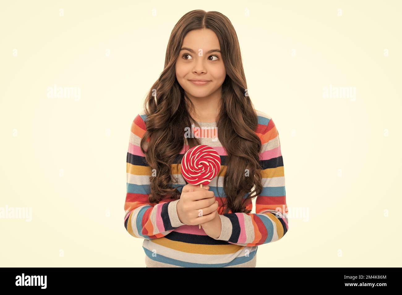 smiling teen girl in sweater with lollipop candy on stick isolated on ...
