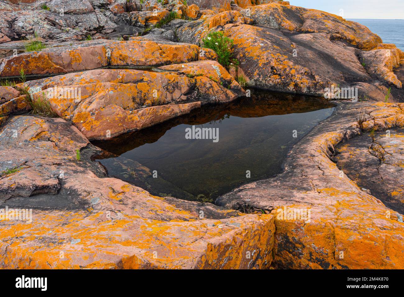 Pools of water and lichen-coated rocks at the Killarney Lighthouse ...