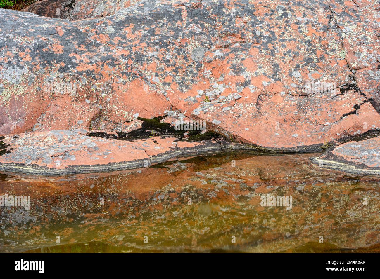 Pools of water and lichen-coated rocks at the Killarney Lighthouse ...