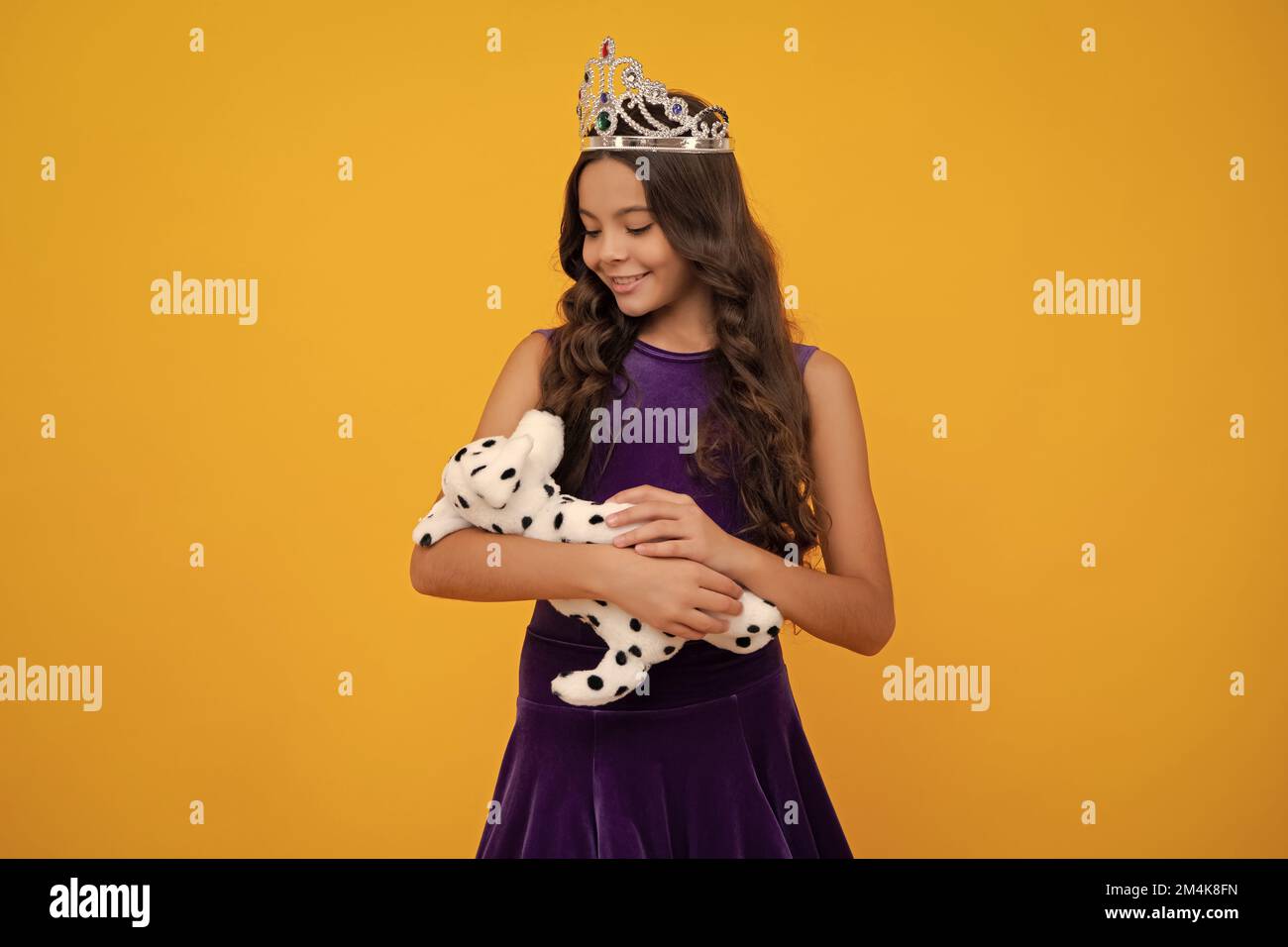 Little queen wearing golden crown. Teenage girl princess holding crown ...