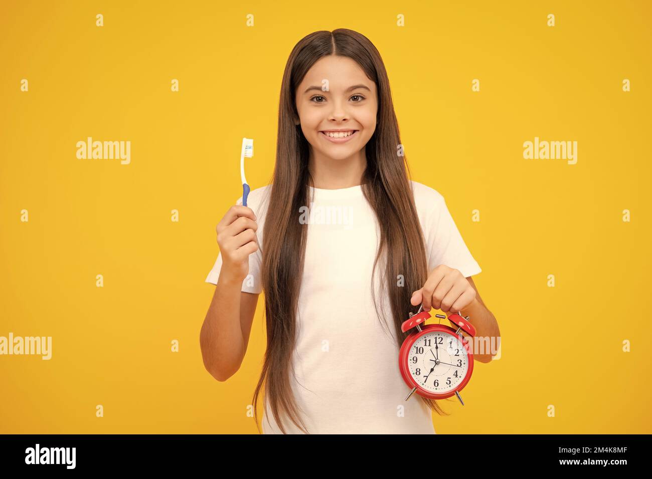 Happy teenager portrait. Girl cleans her teeth with a brush. Time to ...